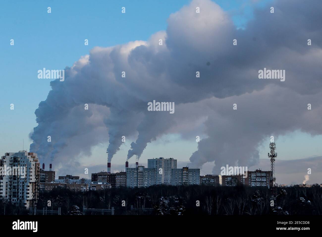Russia, Moscow. Steam rises from cooling towers of a combined heat and ...