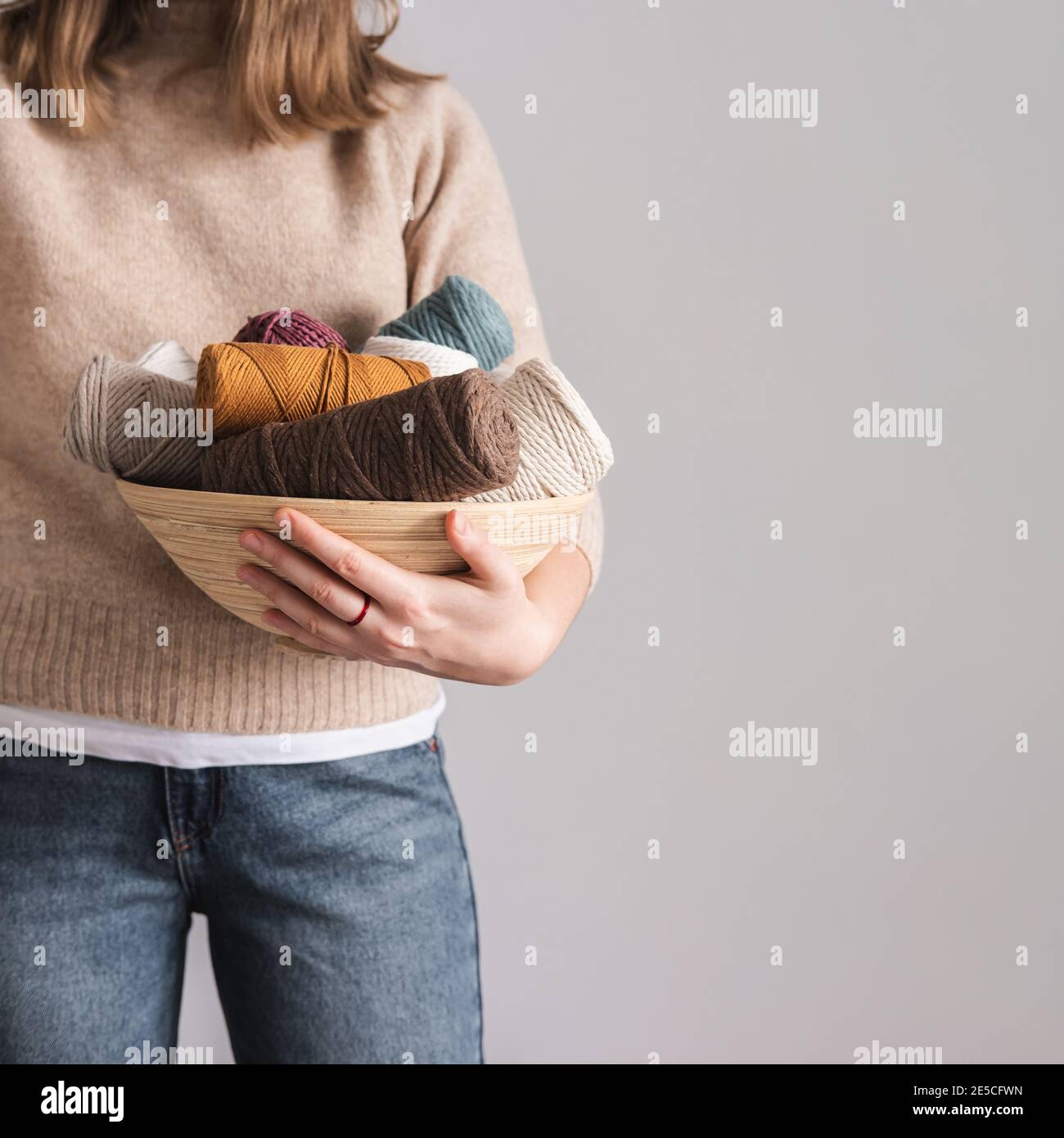 Knitting threads held in a woman's hand. Female person posing with a ...