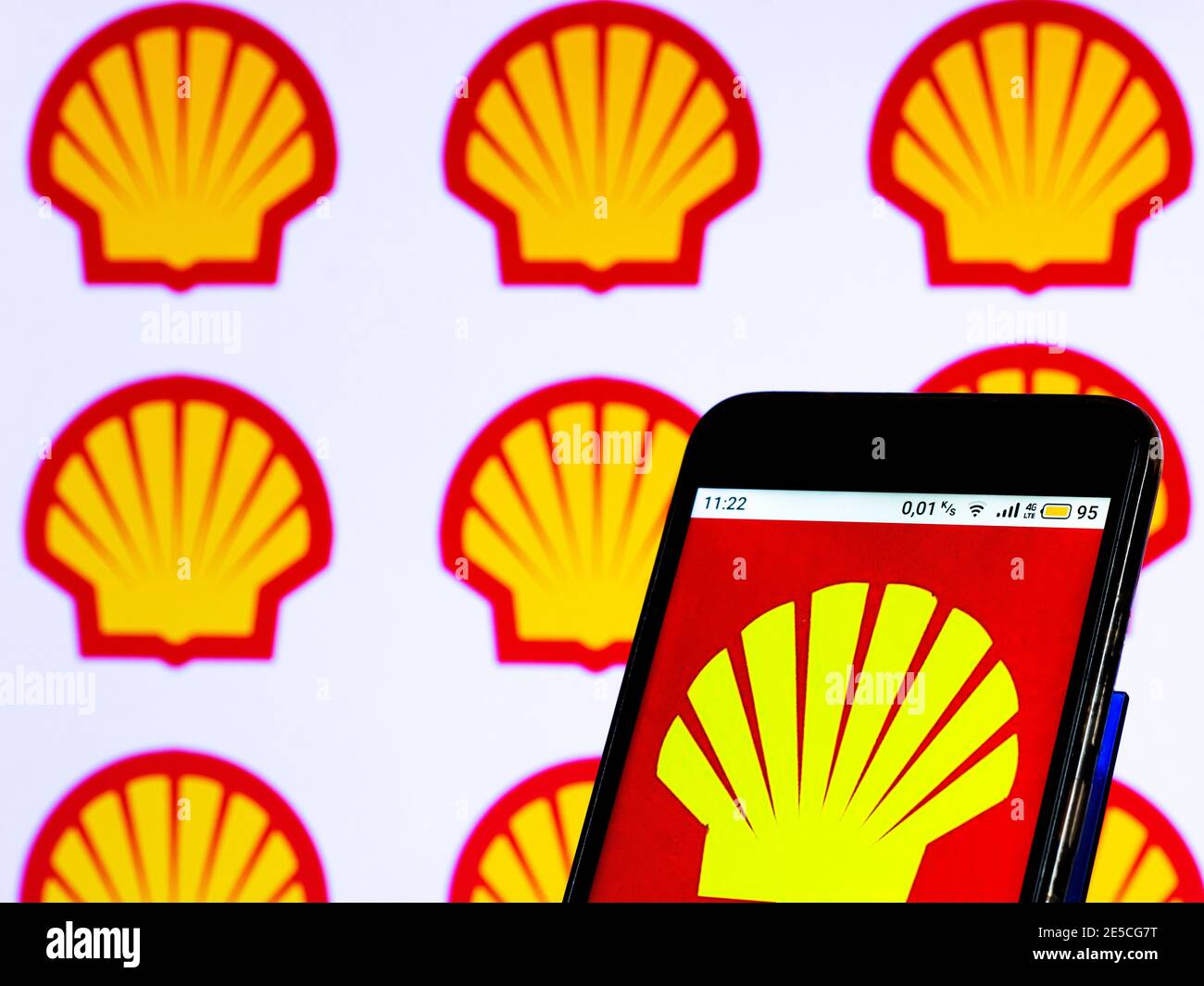 In this photo illustration a Royal Dutch Shell logo seen displayed on a ...