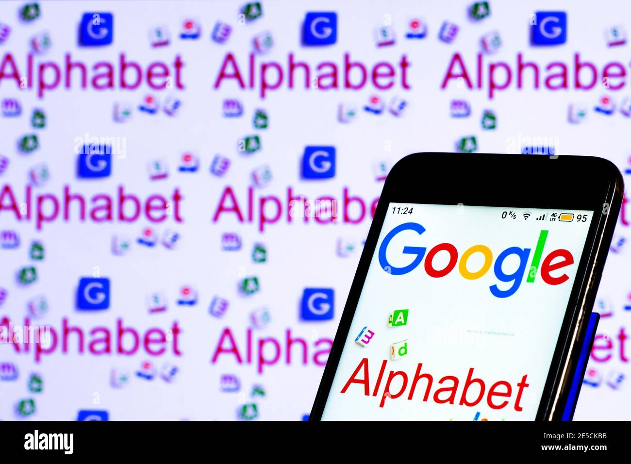 In this photo illustration an Alphabet Inc. logo seen displayed on a ...