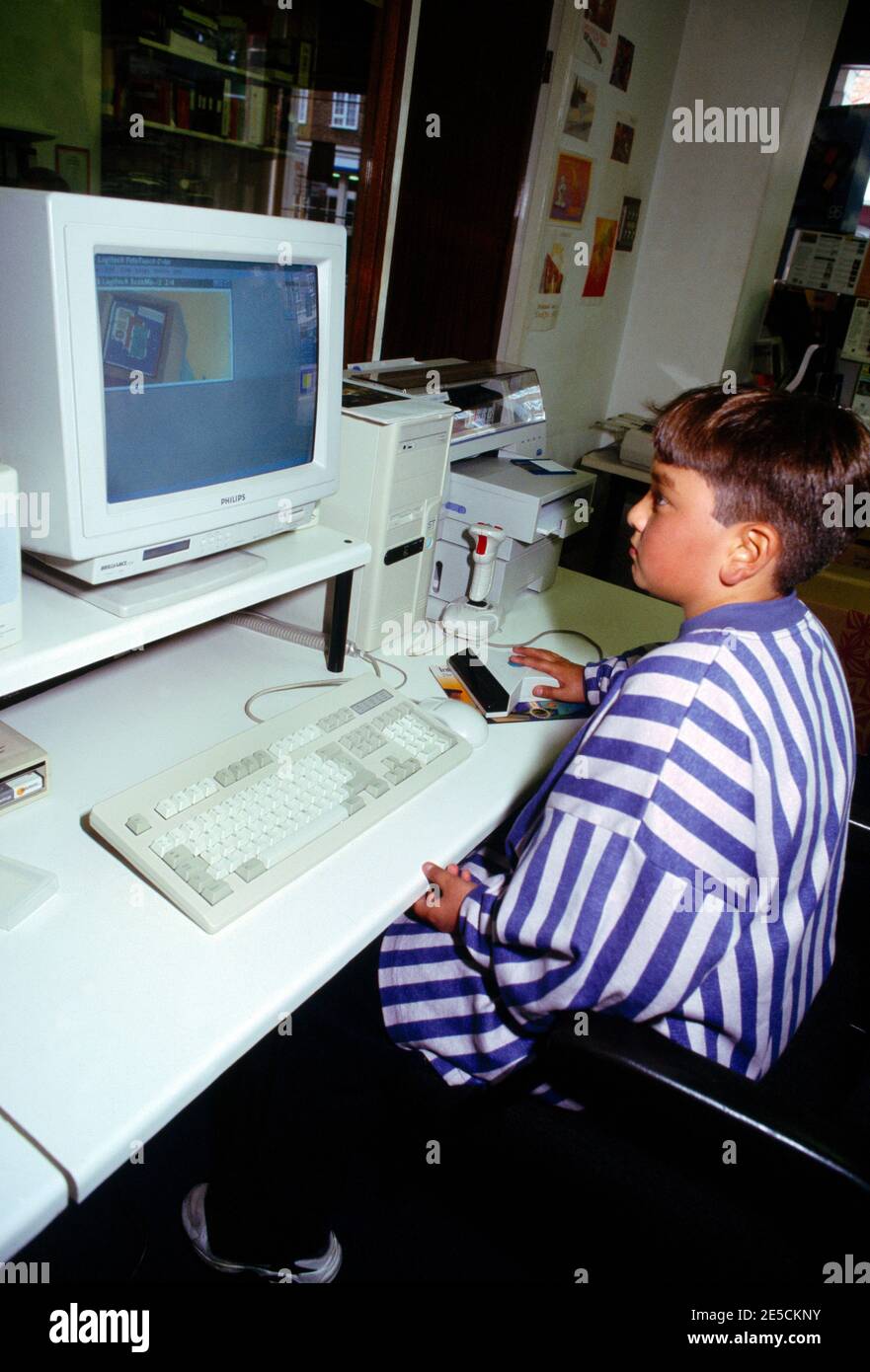 School Boy Scanning Image on to a Computer using a Handheld Scanner ...