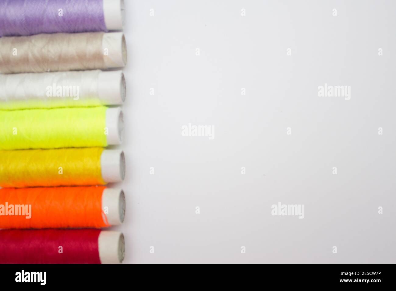 Colored sewing thread, background, Copy space Stock Photo - Alamy