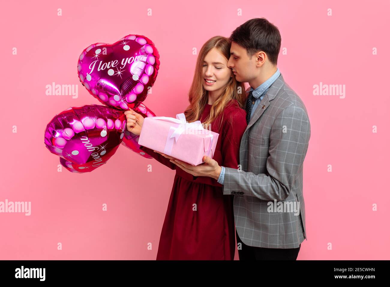 Beautiful loving young couple cuddling having fun together celebrating ...