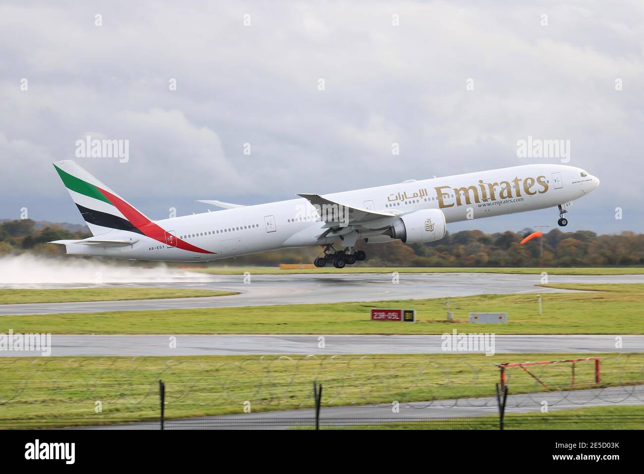 Emirates Boeing 777 300ER departing Manchester Airport for Dubai Stock ...