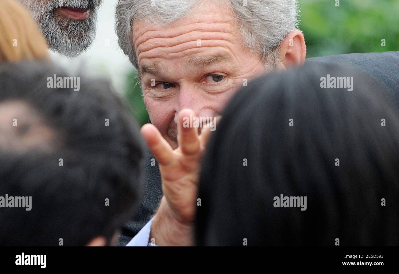 U.S. President George W. Bush checks hands with his staff and thanks ...
