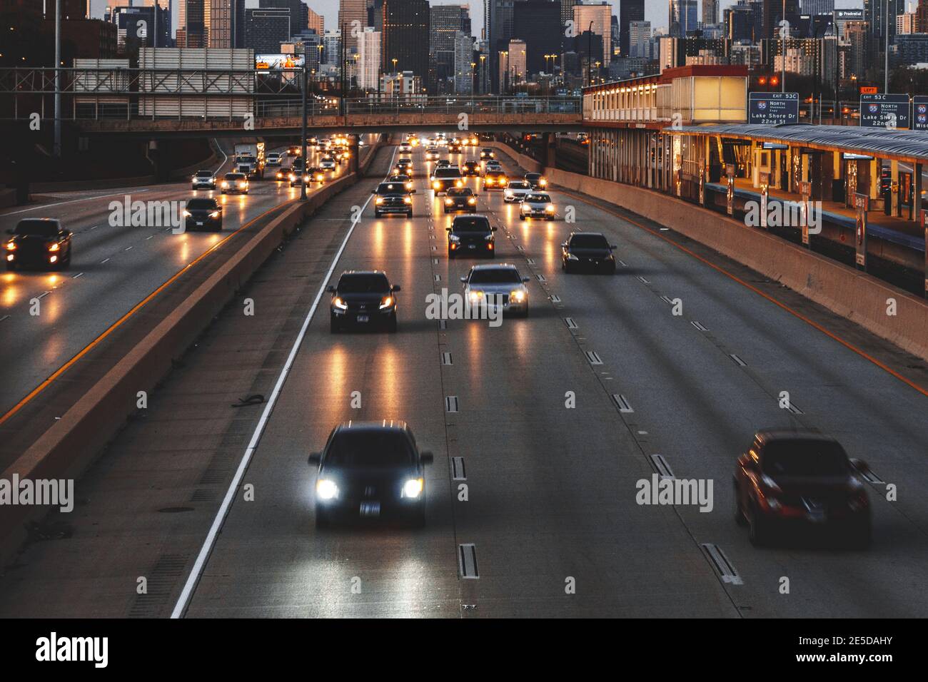 City skyline and cars driving along freeway at sunset, Chicago ...