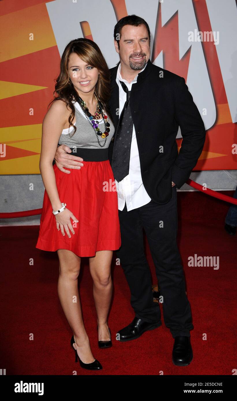 Cast members Miley Cyrus and John Travolta attend the World Premiere of ...