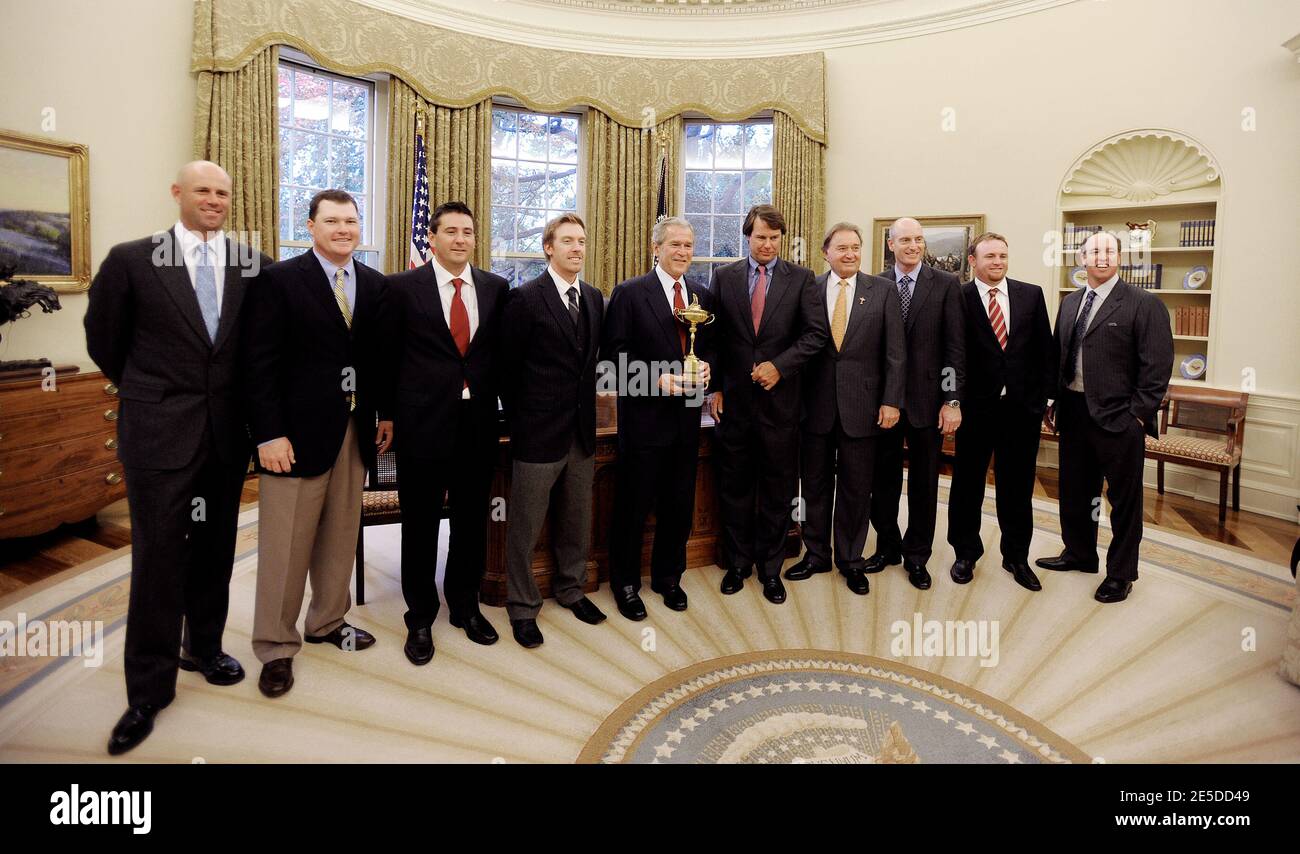 U.S. President George W. Bush (C) holds the 2008 Ryder Cup trophy as he ...