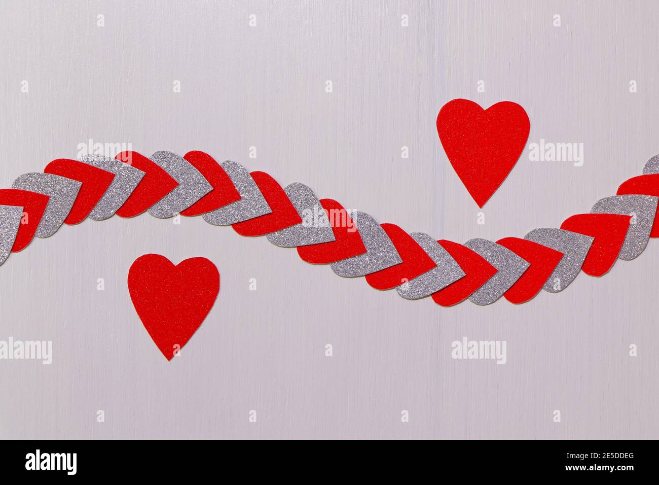 Two Red Hearts Apart With String Of Hearts On Textured White Stock ...