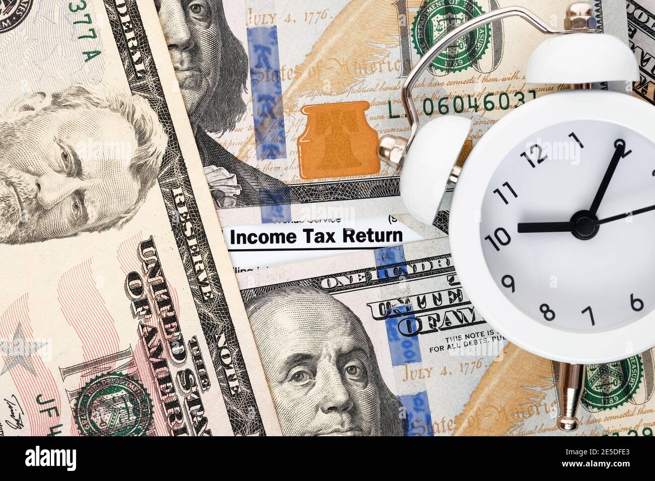 Personal income tax form 1040, dollar bills, alarm clock Stock Photo ...