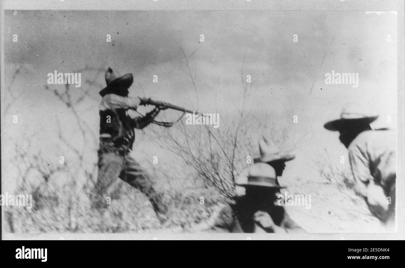 Mexican insurrection activities- Insurrecto firing rifle on crest of ...