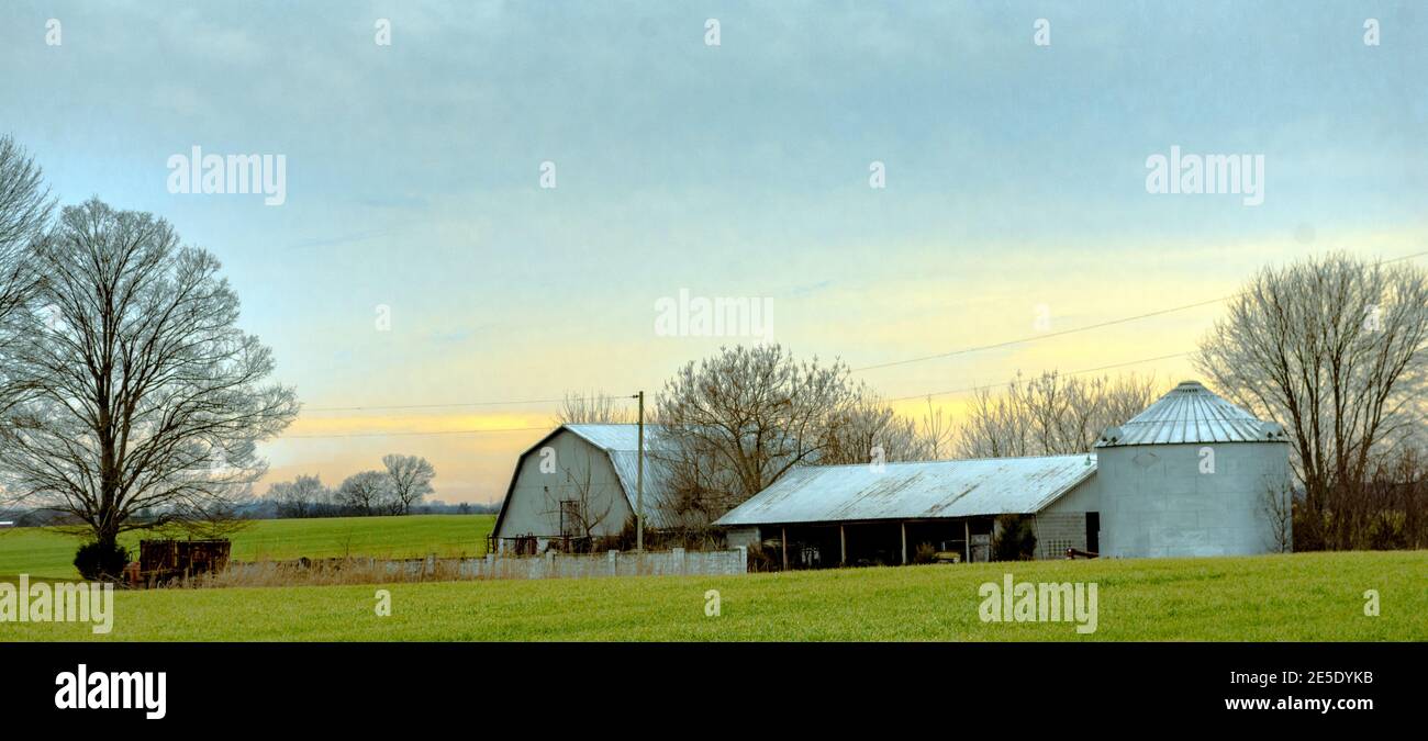 Farm background with barn, sheds and storage bins with blank sky at the ...