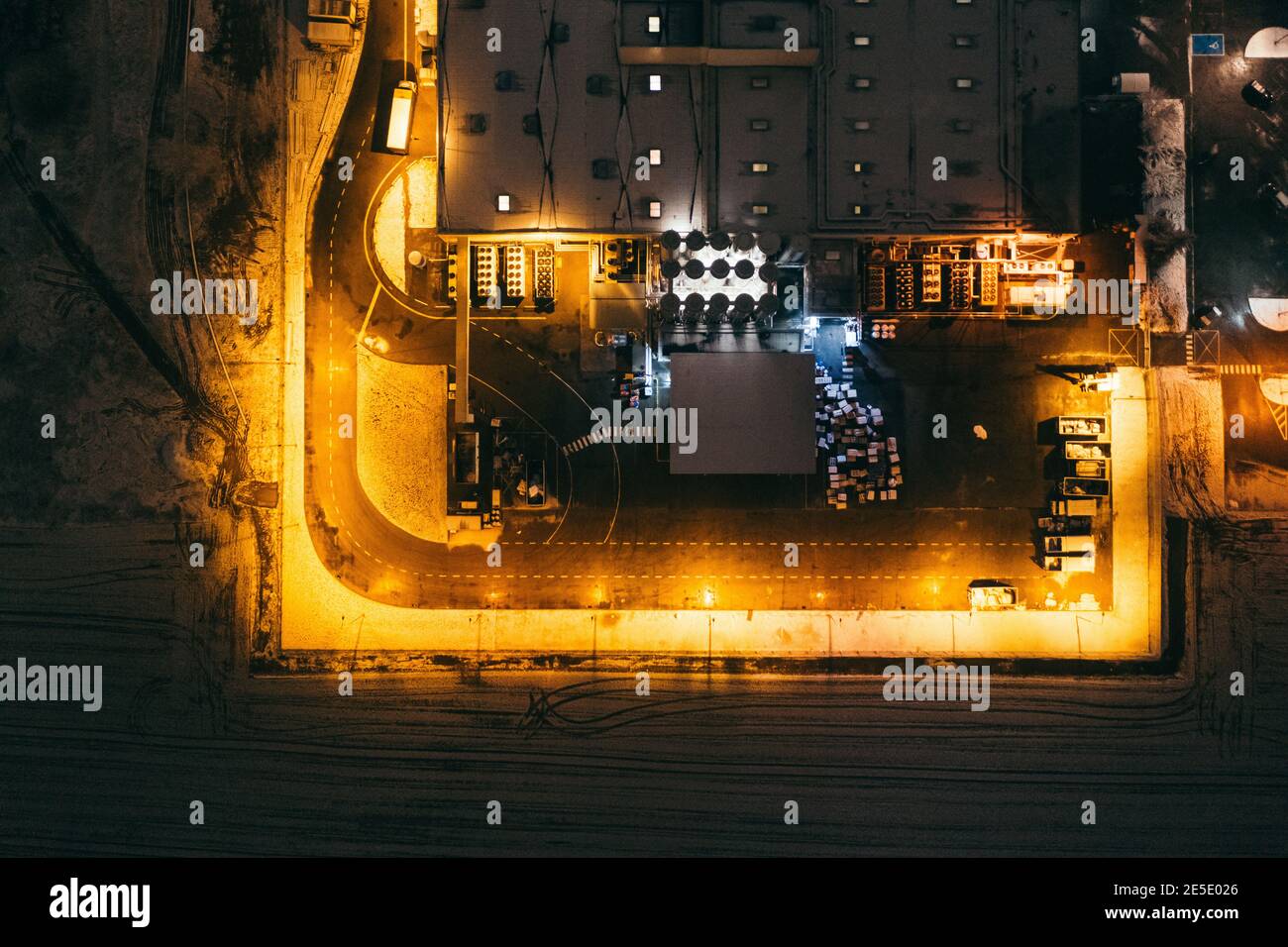 Aerial view of the trucks unloading at the logistic center. Night view ...