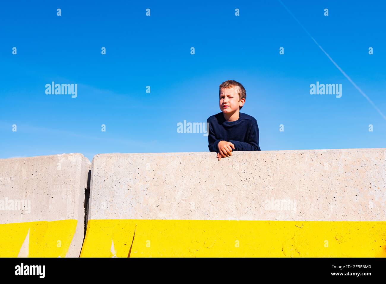A child play on some construction barriers running into danger ...