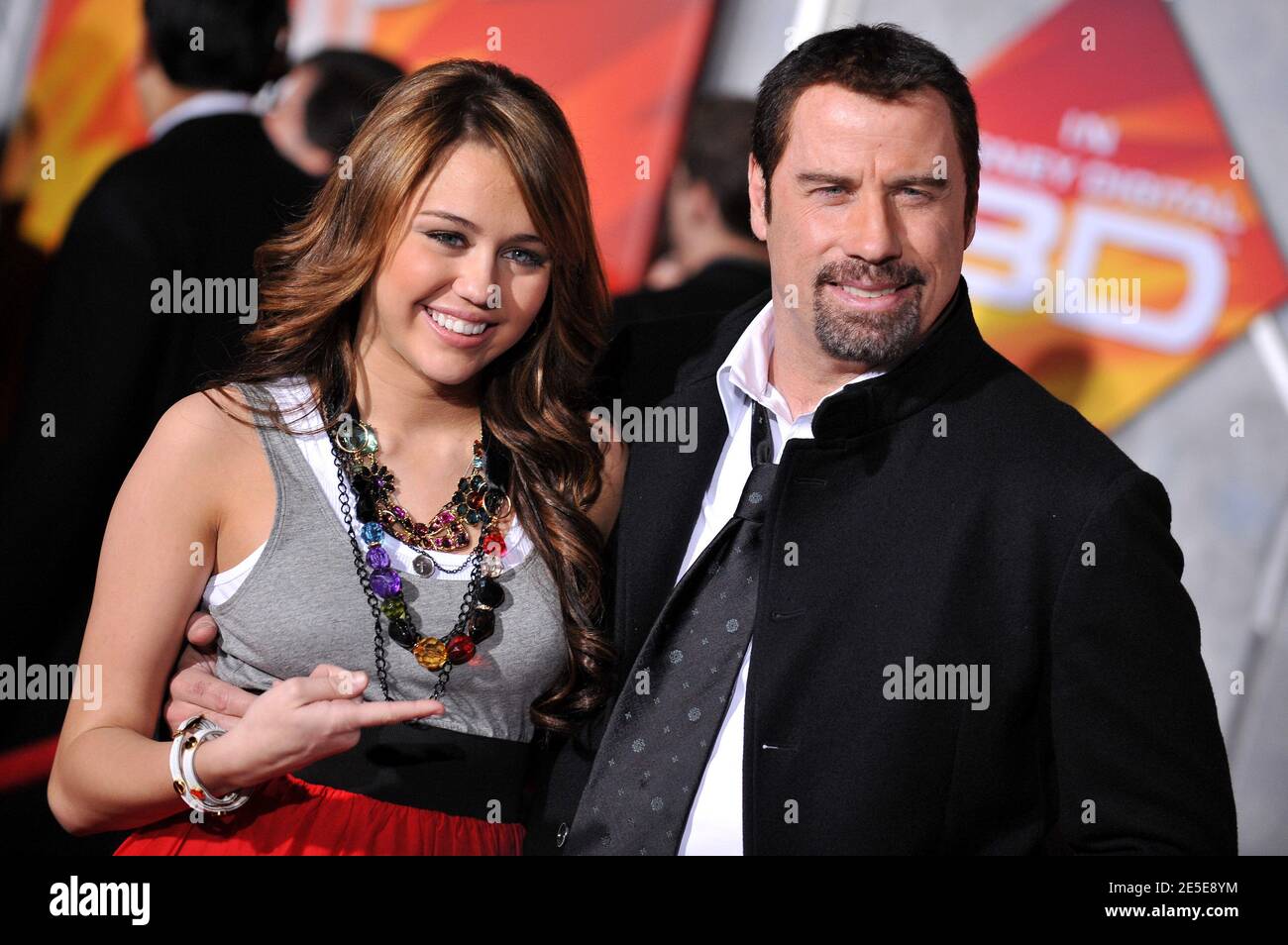 Cast members Miley Cyrus and John Travolta attend the World Premiere of ...
