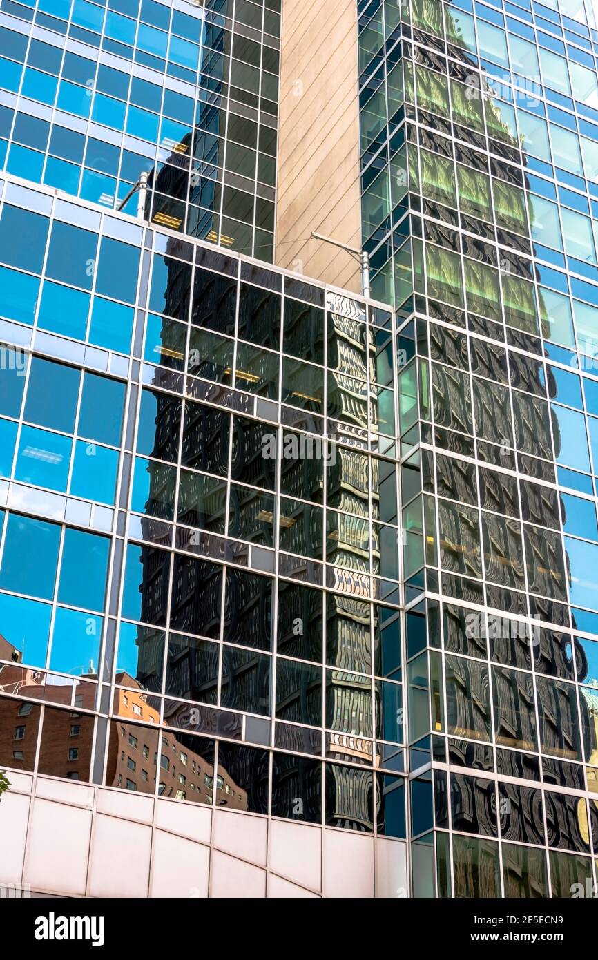 Reflections of neighboring buildings as seen in high rise skyscrapers ...