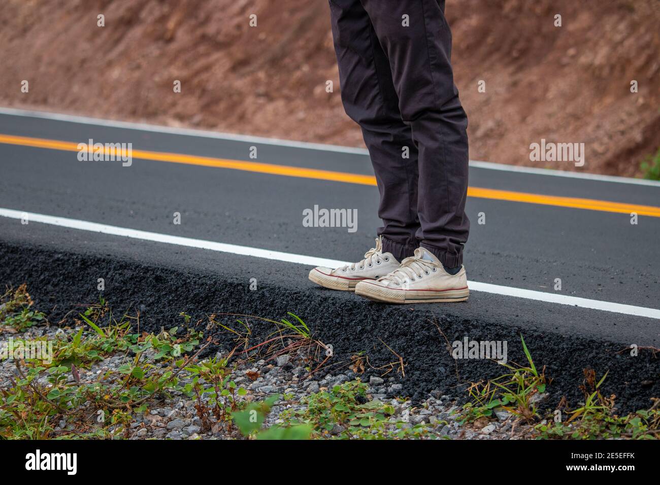 Men wearing sneakers walking on the streets with yellow lines Stock ...