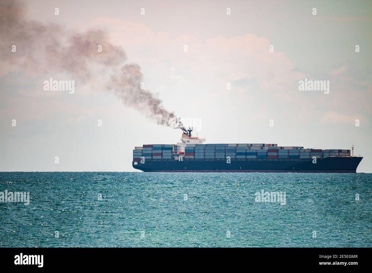 Container ships in the sea have a lot of black smoke Stock Photo - Alamy
