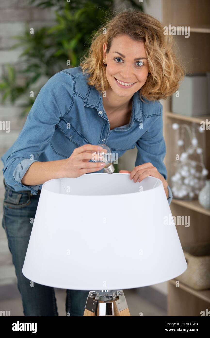 Woman changing bulb hi-res stock photography and images - Alamy