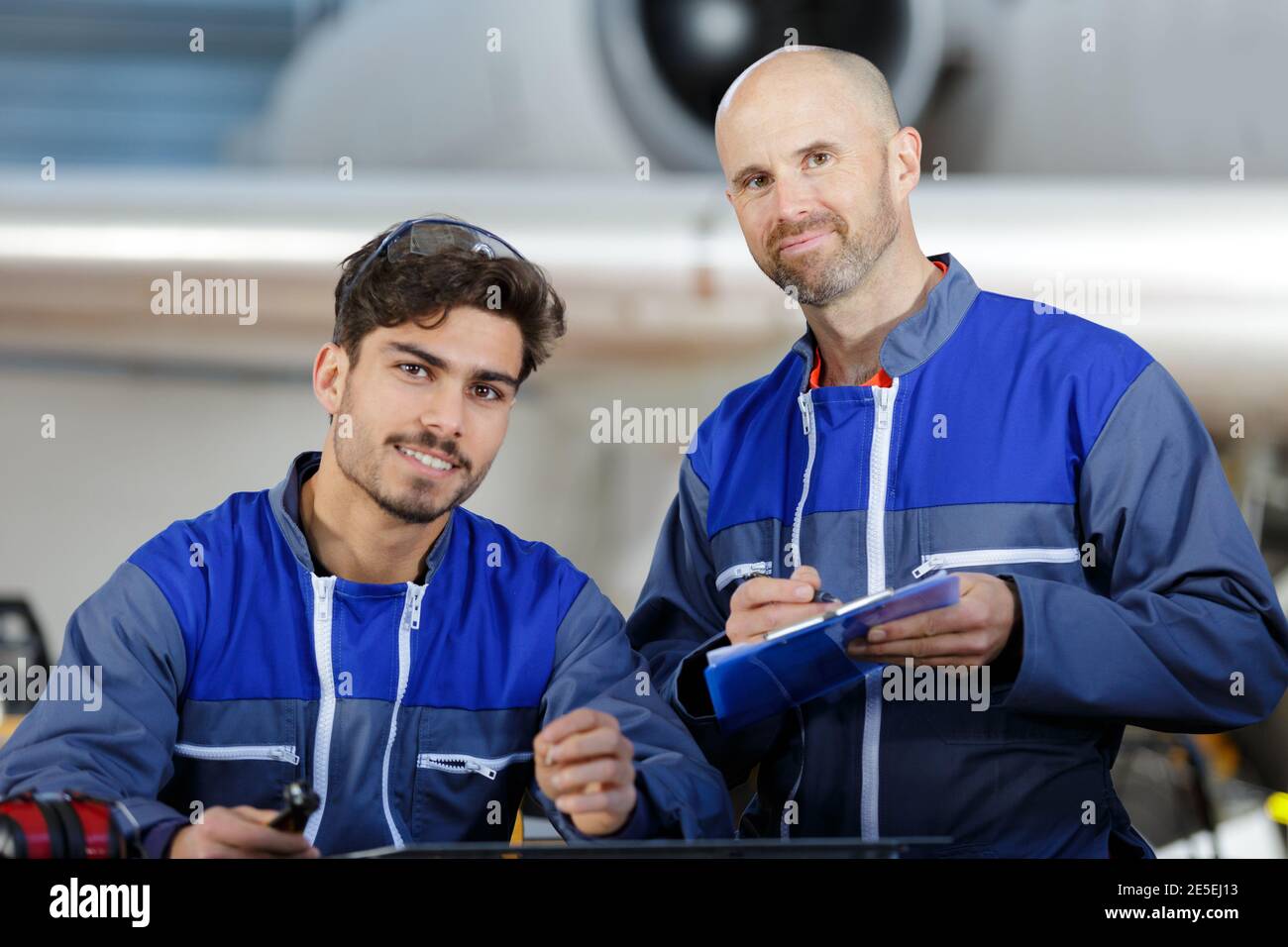 two mechanics working in auto service Stock Photo - Alamy