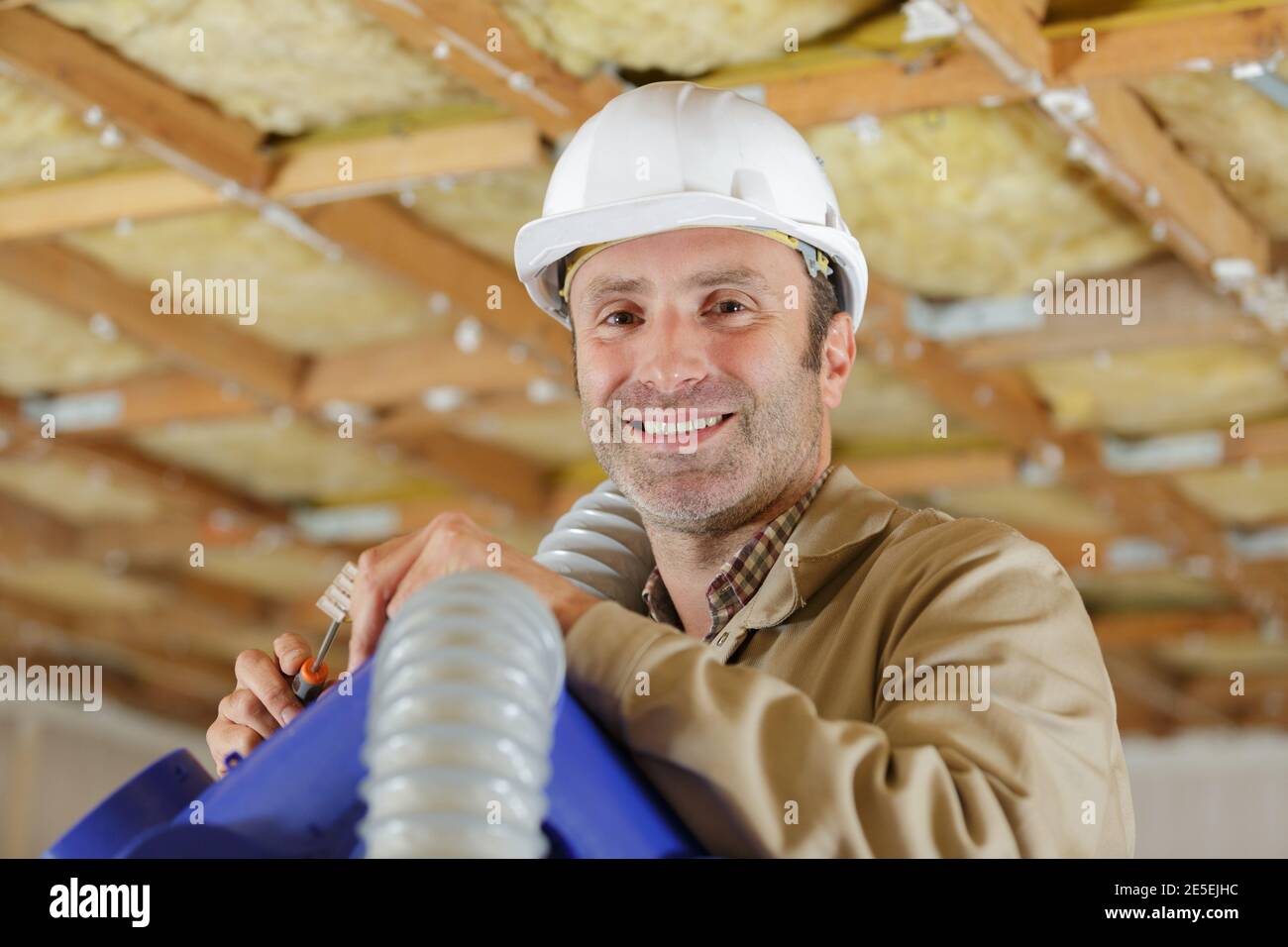 a male worker assembling the ventilation box Stock Photo - Alamy