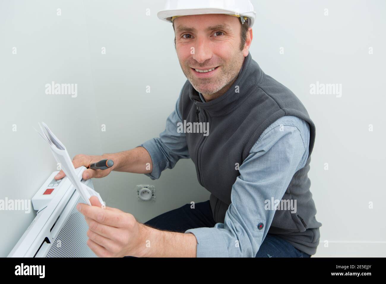 man fixing an industrial heater Stock Photo - Alamy