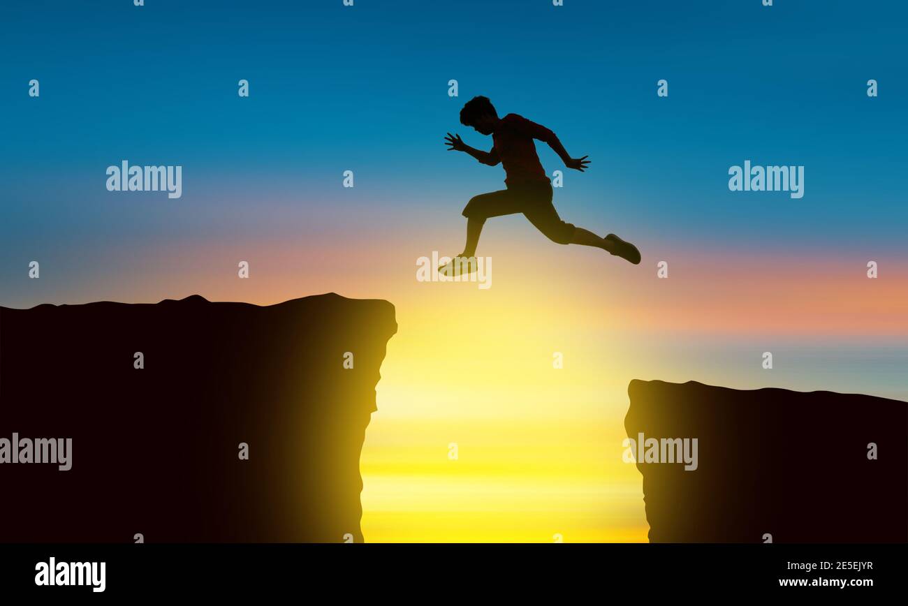 The silhouette of a man jumping over the abyss At the time of the sun ...