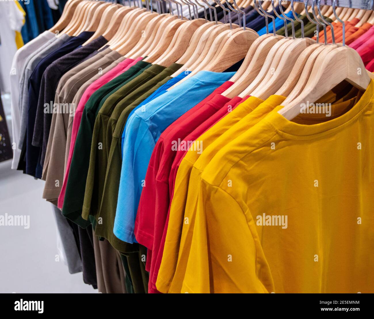 Fashion clothes on clothing rack - bright colorful closet. Close-up of ...