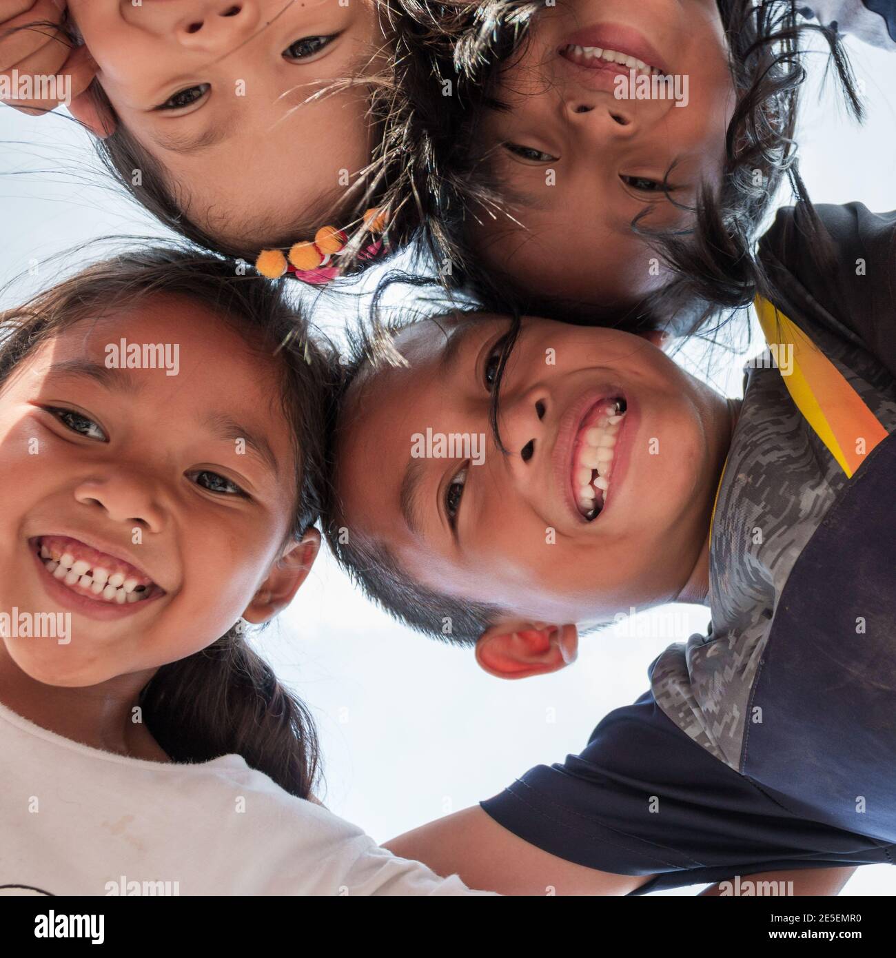 Team happy kids embracing together hi-res stock photography and images ...