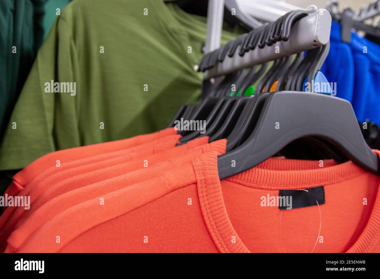Fashion clothes on clothing rack - bright colorful closet. Close-up of ...