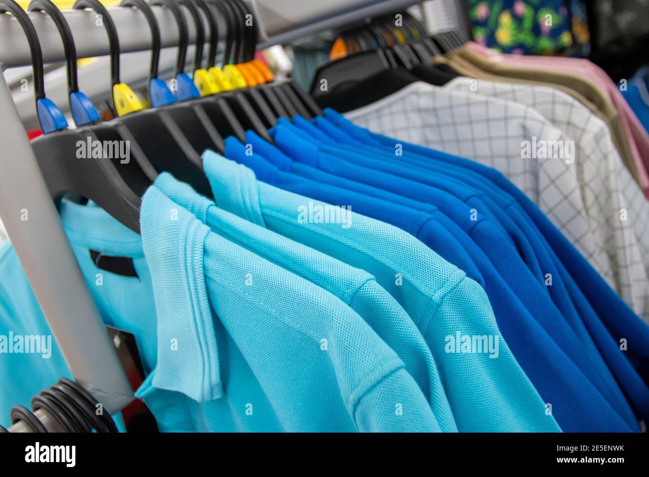 Fashion clothes on clothing rack - bright colorful closet. Close-up of ...