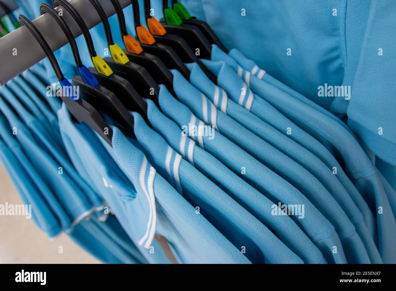 Fashion clothes on clothing rack - bright colorful closet. Close-up of ...