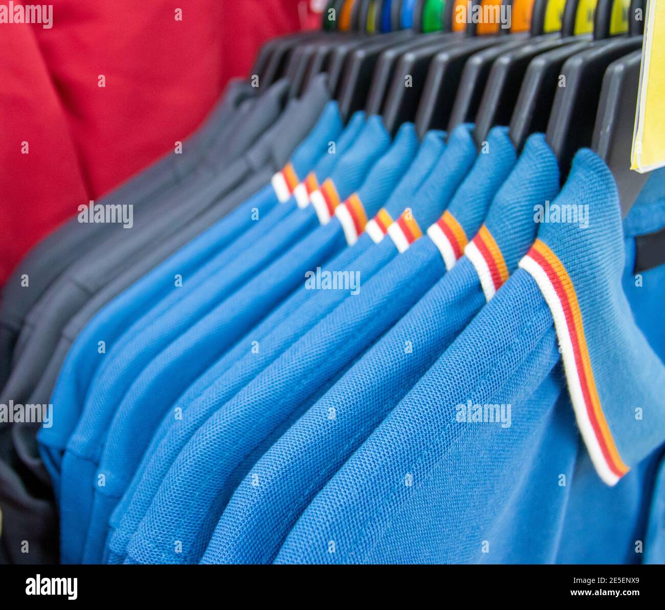 Fashion clothes on clothing rack - bright colorful closet. Close-up of ...