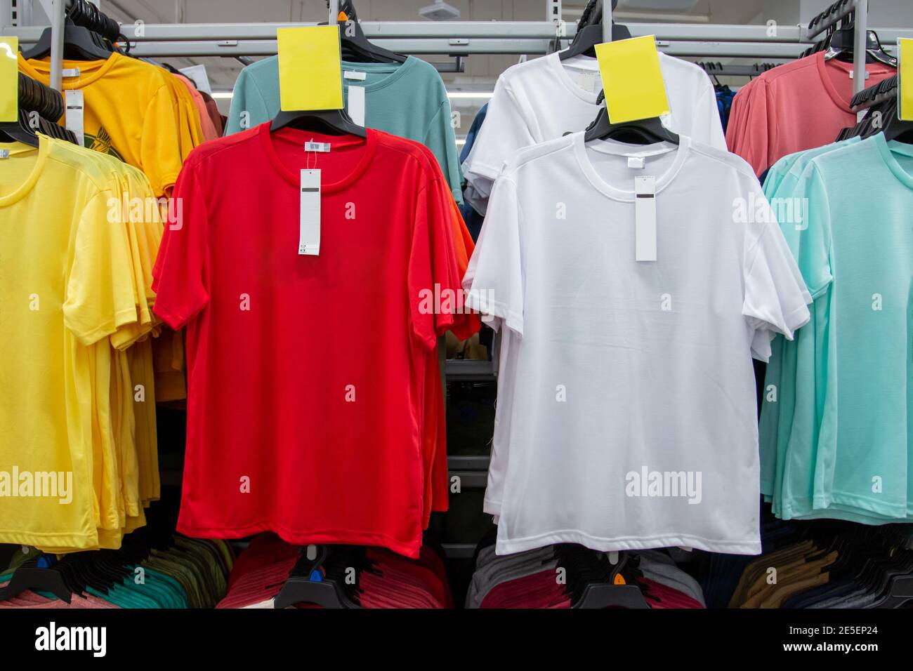 Fashion clothes on clothing rack - bright colorful closet. Close-up of ...