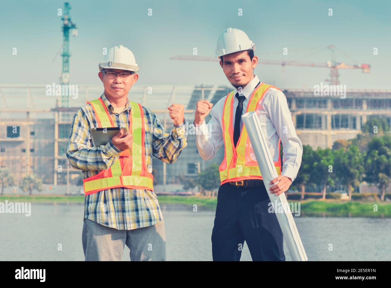 Two Engineer standing on site construction happy success, Two worker ...