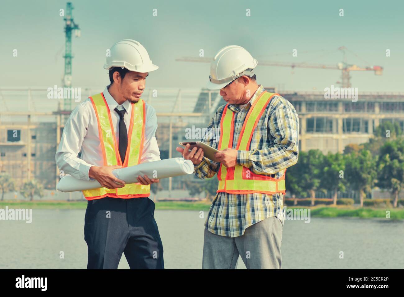 Two Engineer standing on site construction happy success, Two worker ...