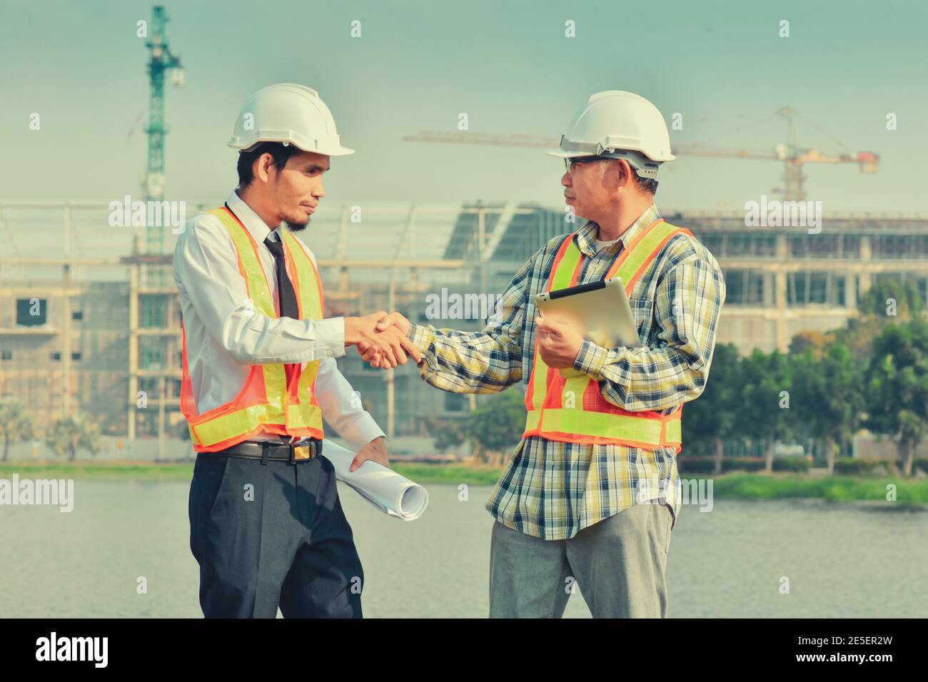 Two Engineer standing on site construction happy success, Two worker ...