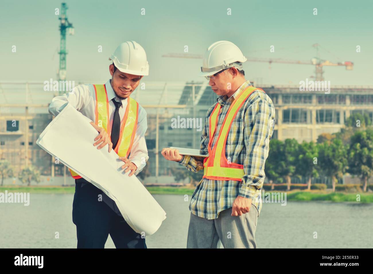 Two Engineer standing on site construction happy success, Two worker ...