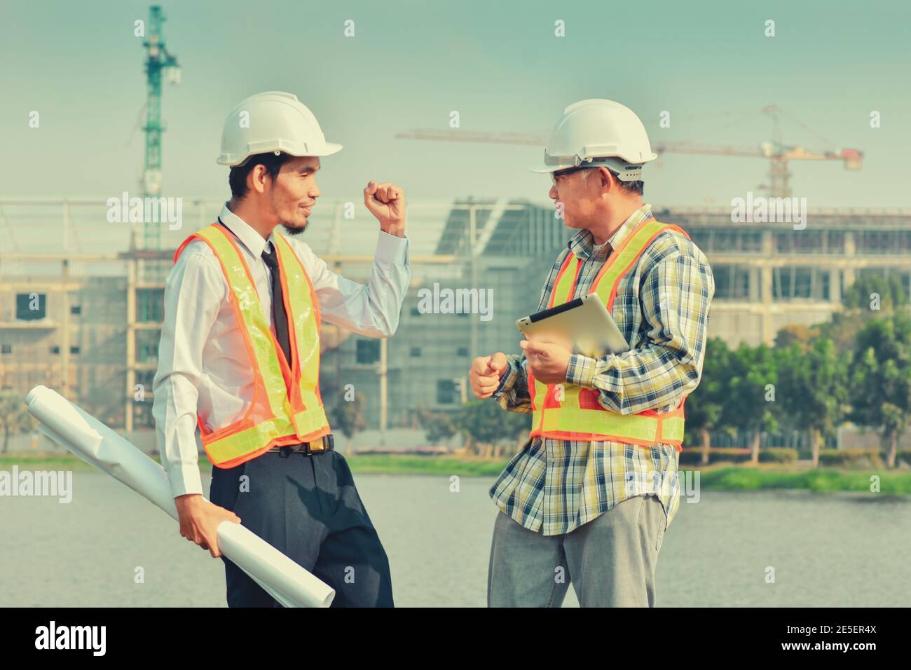 Two Engineer standing on site construction happy success, Two worker ...