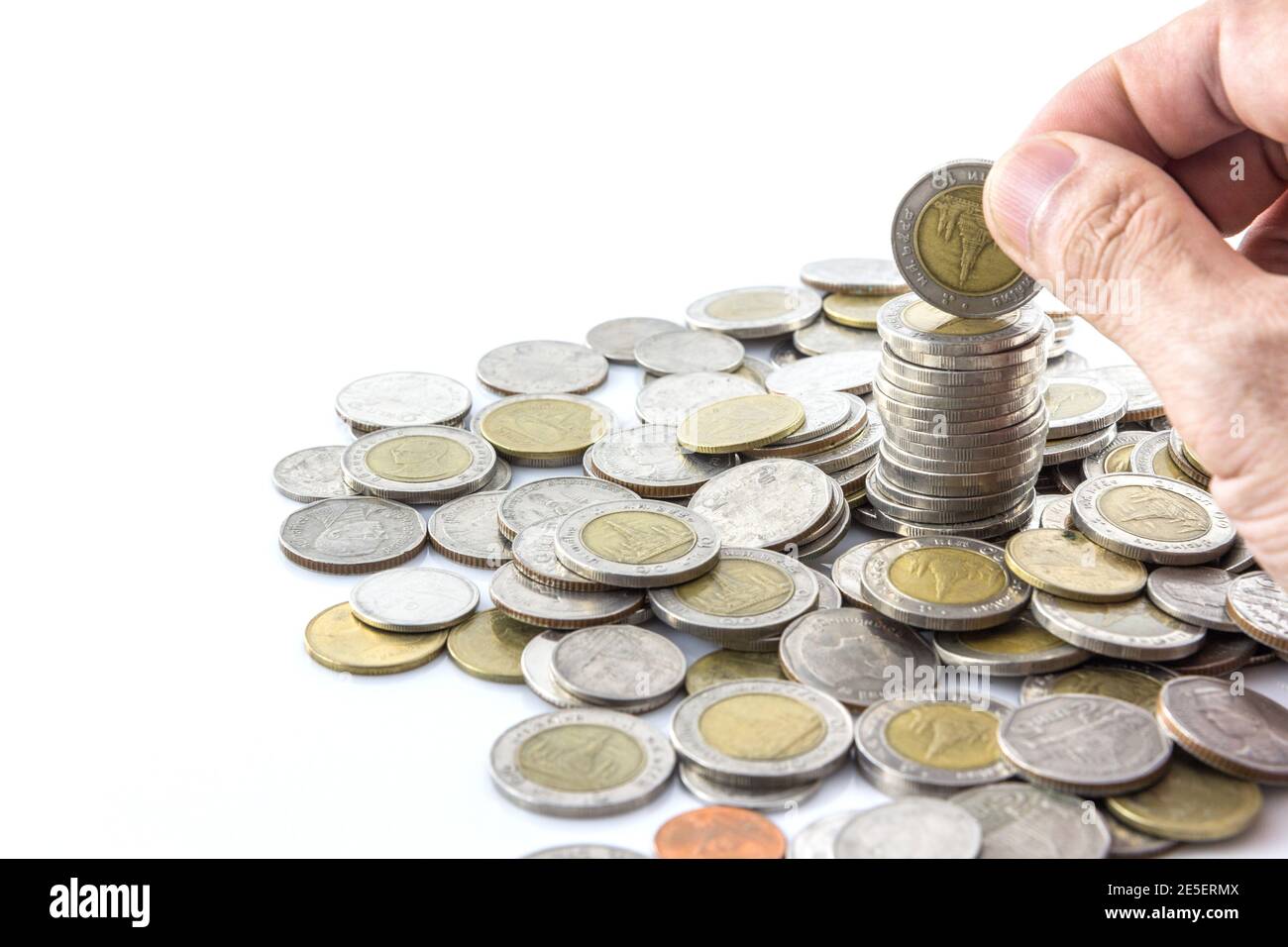 Hand put coins to stack of coins on white background Stock Photo - Alamy