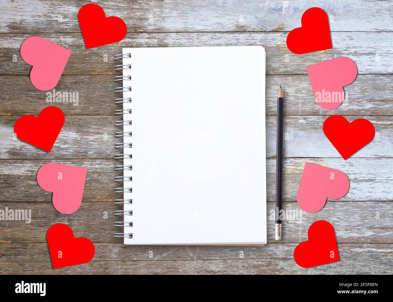 Blank notebooks or notepad,pencil,red and pink paper heart on wood ...