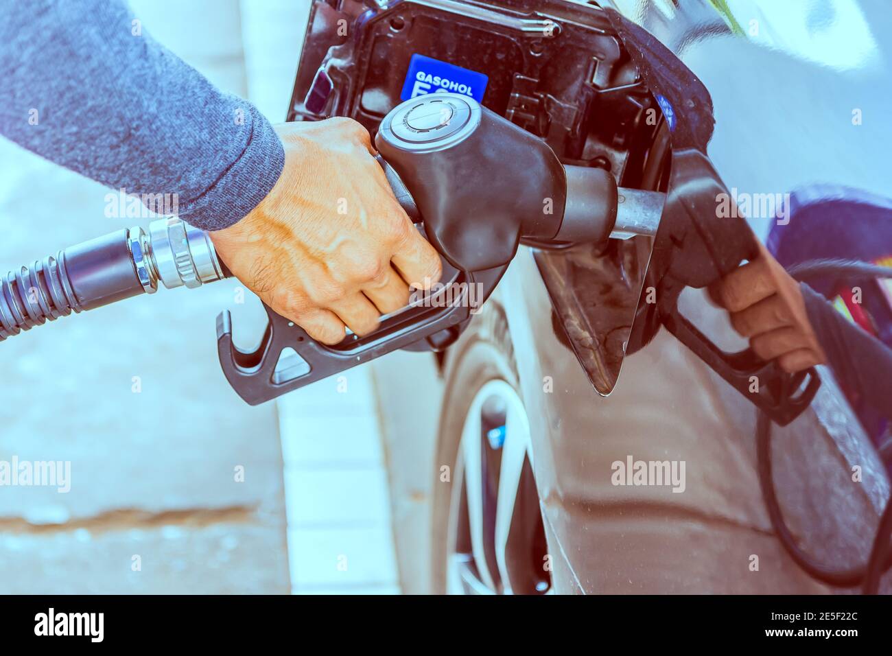 Fuel nozzle add fuel in car at gas station Stock Photo - Alamy