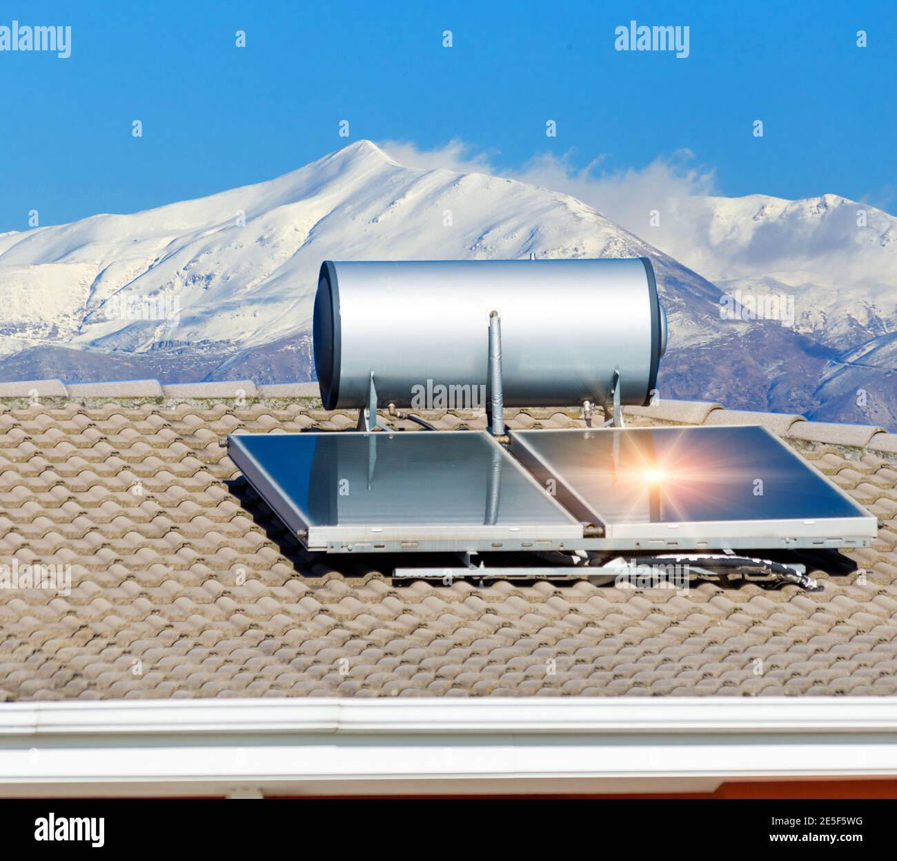 sun solar heater panels on the roof sun mountain snow ice in winter ...