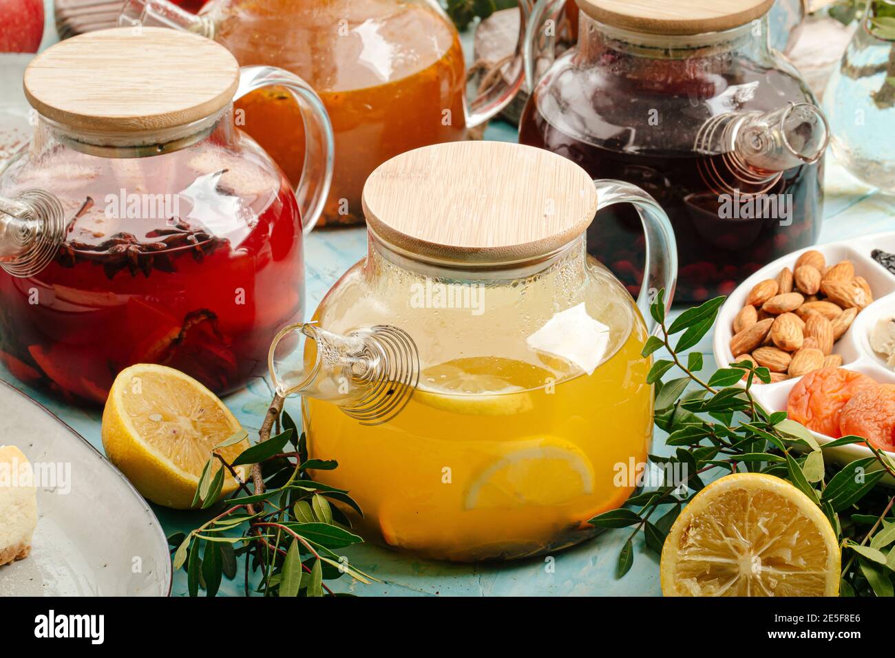 Assorted fruit tea in glass pots on the blue Stock Photo - Alamy