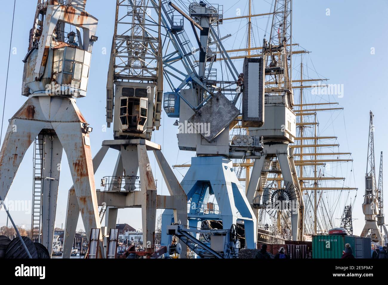 Hamburg, Germany. 25th Dec, 2020. Historic harbour cranes and the masts ...