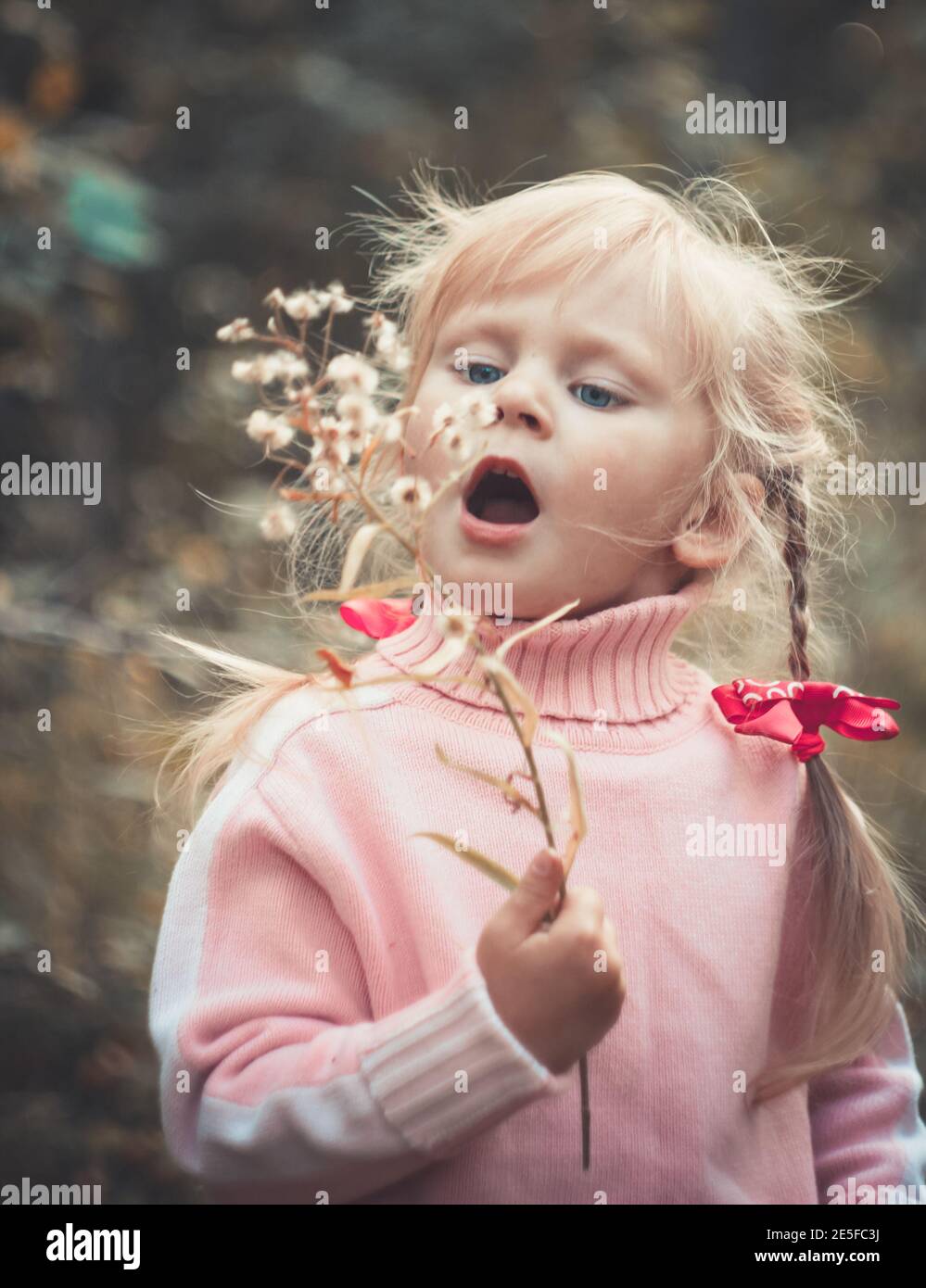 Girl blowing dandelion hi-res stock photography and images - Alamy