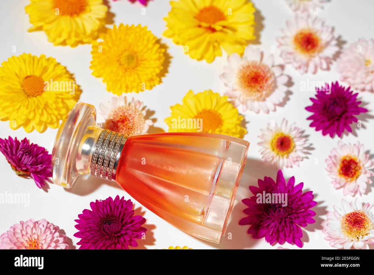 Perfume bottle for women in flower buds Stock Photo - Alamy
