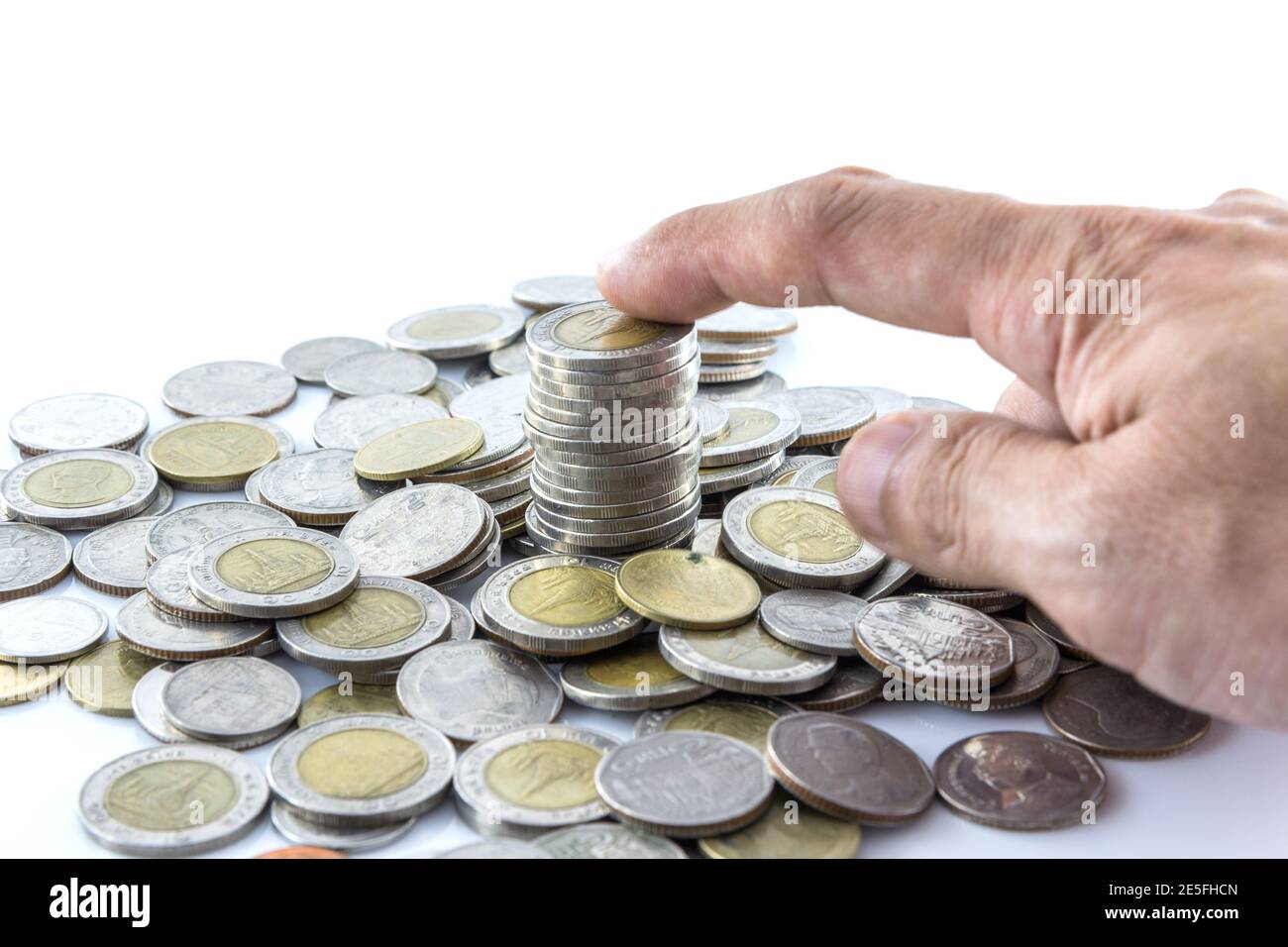 Hand put coins to stack of coins on white background Stock Photo - Alamy