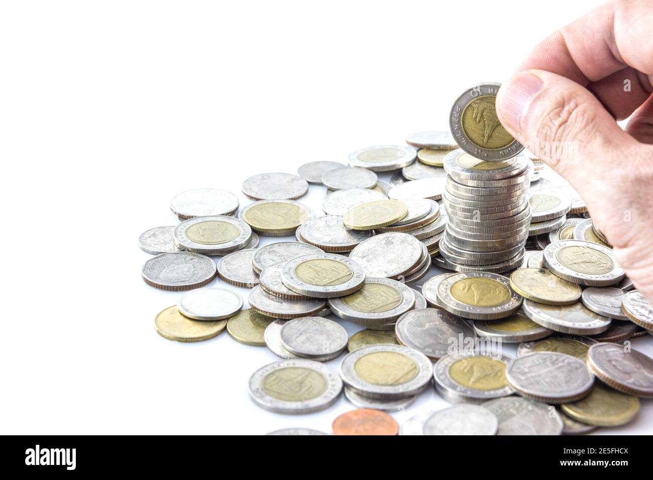 Hand put coins to stack of coins on white background Stock Photo - Alamy