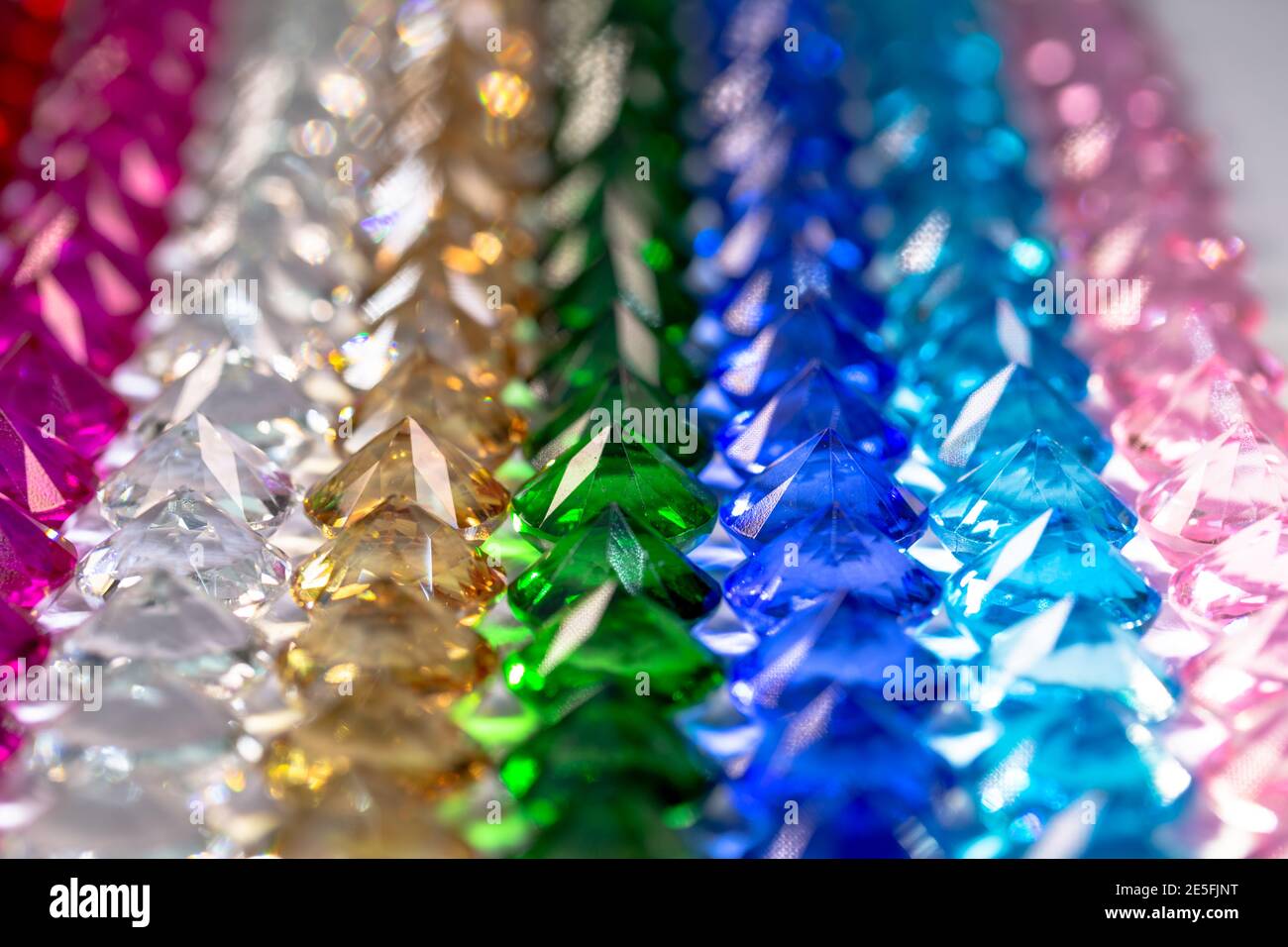 Colorful diamonds are arranged neatly in a row on a white floor Stock ...